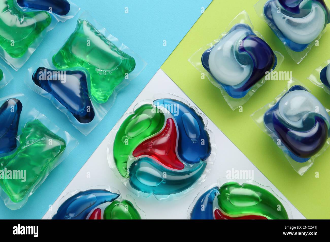 Different laundry capsules on color background, flat lay Stock Photo ...