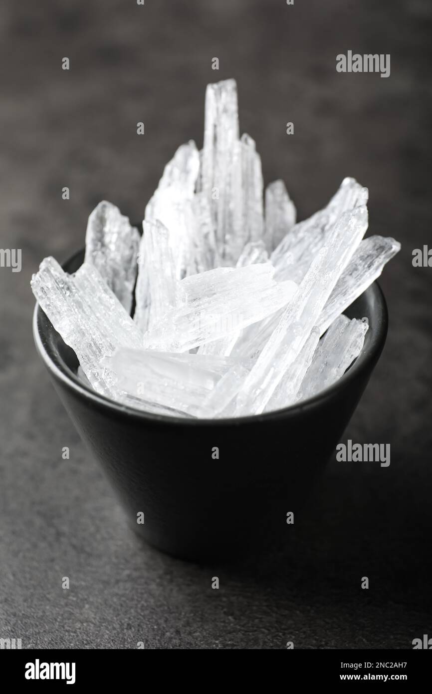 Menthol crystals in bowl on grey background Stock Photo - Alamy