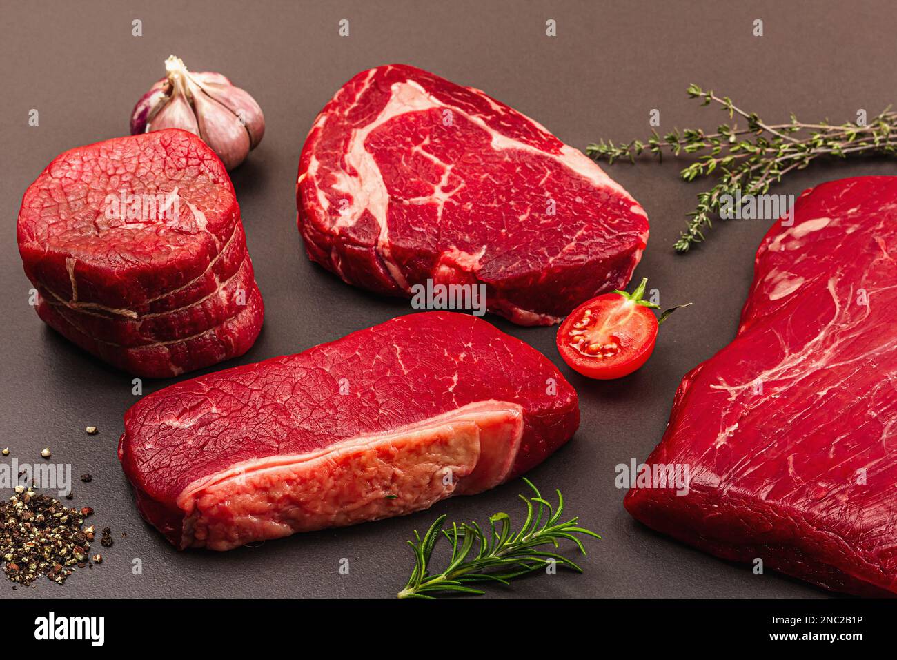 Set of various steaks with classic spices and herbs. Fresh raw meat ...