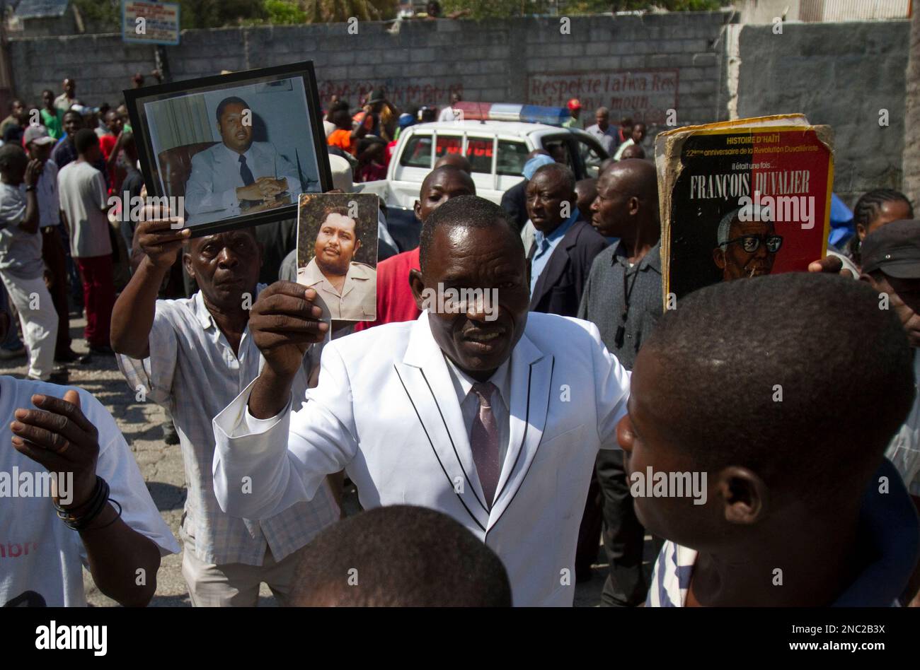 Supporters of former Haitian dictator Jean-Claude Duvalier display ...