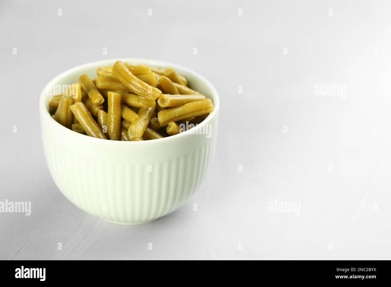 Canned green beans on light grey table. Space for text Stock Photo - Alamy