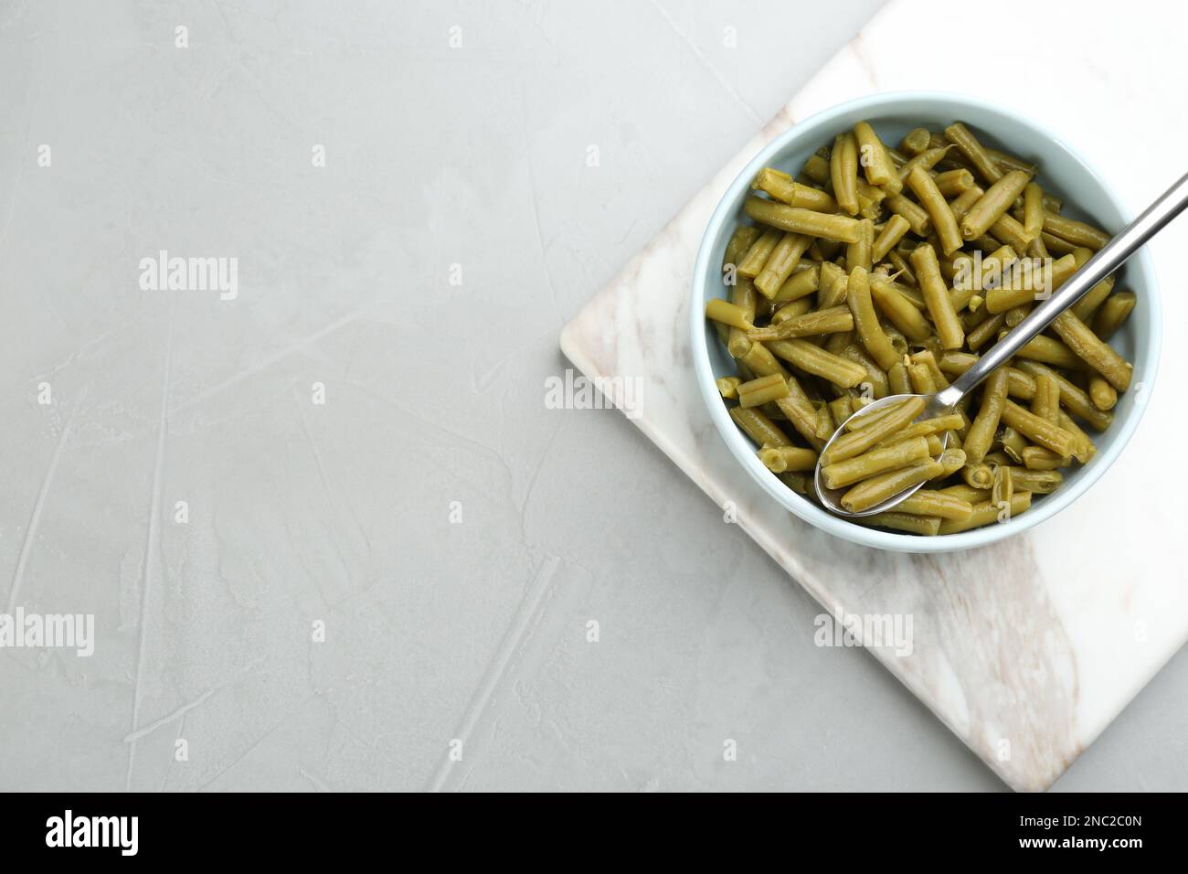 Canned green beans on light grey table, top view. Space for text Stock ...