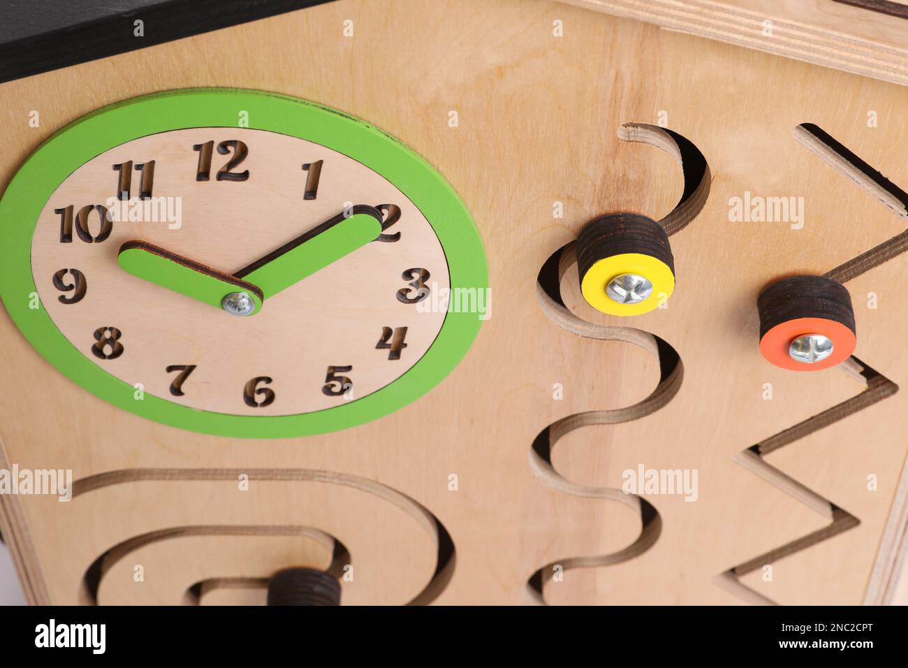Closeup view of busy board. Baby sensory toy Stock Photo - Alamy