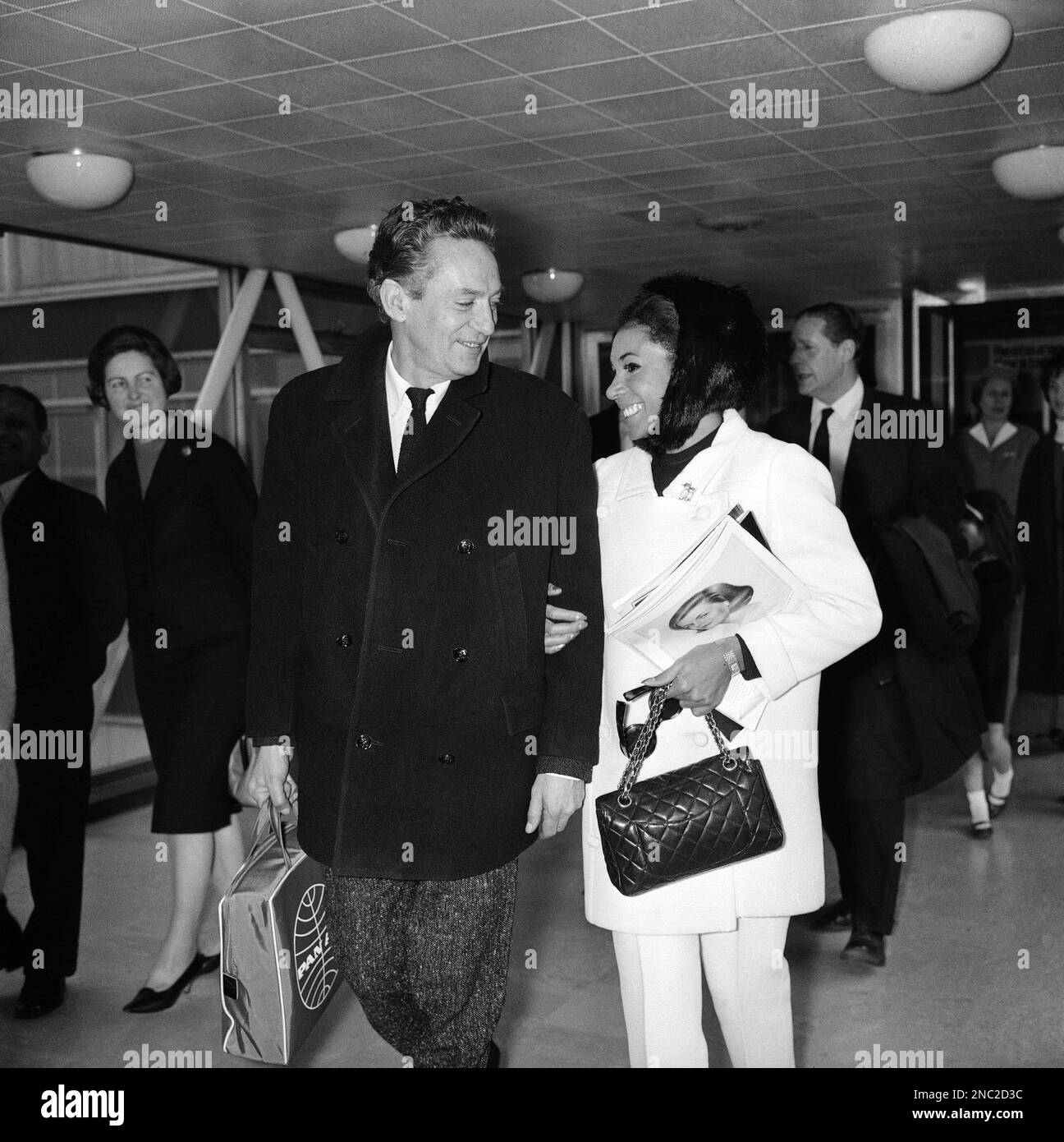 Singer Shirley Bassey with actor Peter Finch at London Airport, England ...