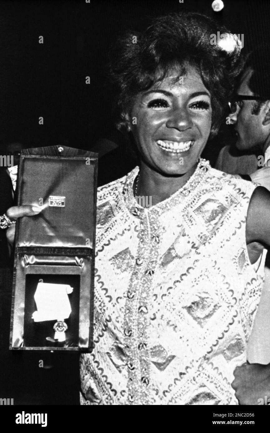 British singer Shirley Bassey smiles as she shows the Silver Mask prize ...