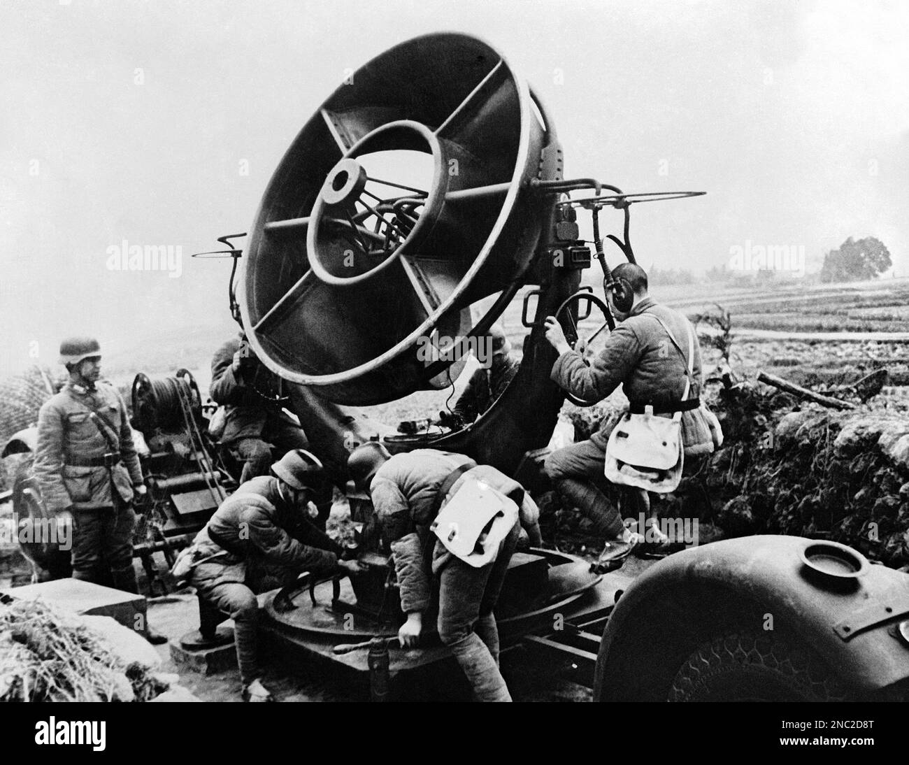 A Chinese Anti-Aircraft crew swinging its giant plane-detector towards ...