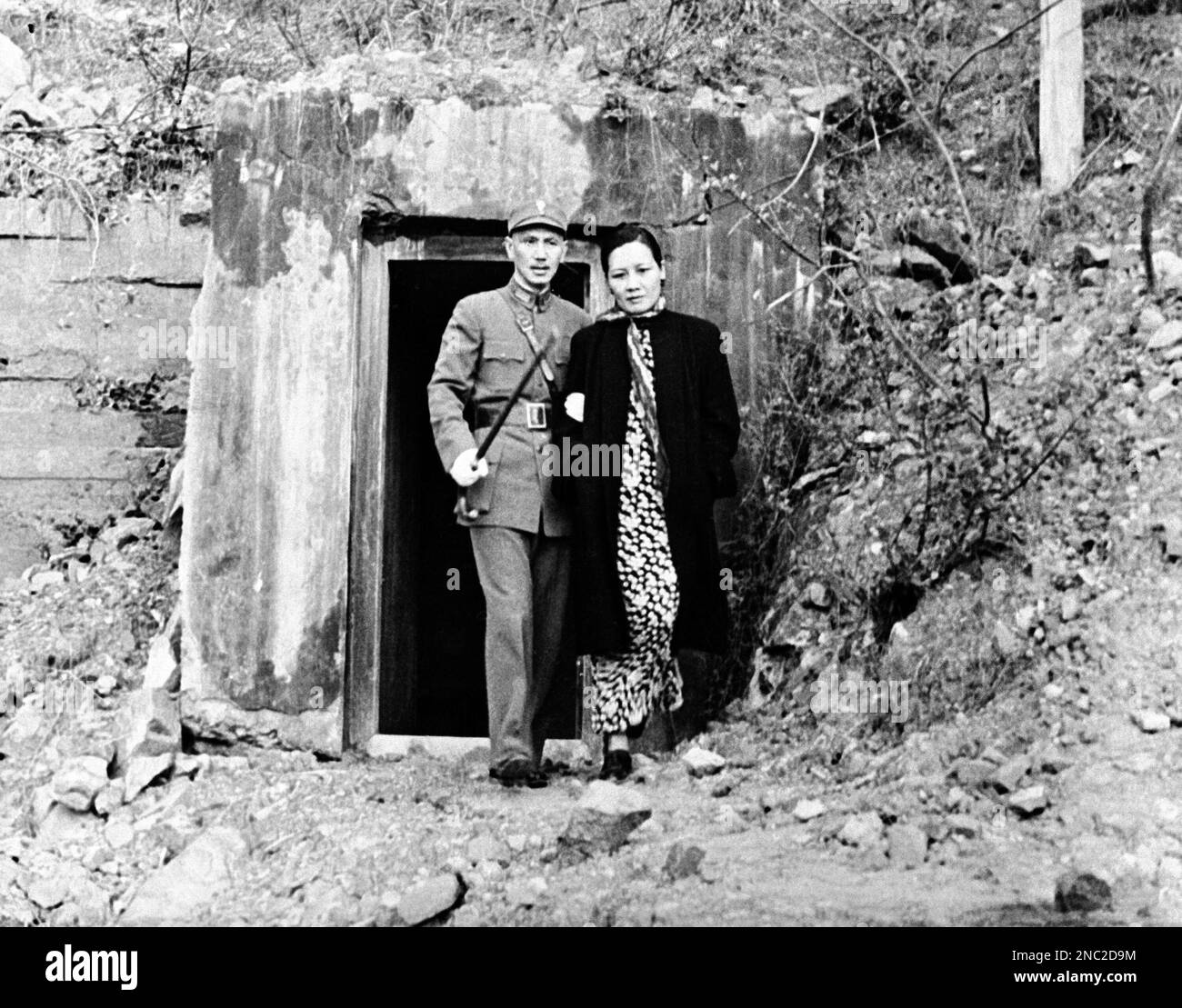 Generalissimo Chiang Kai Shek and his wife Madame Chiang Kai-Shek, emerging from a dug-out on ...