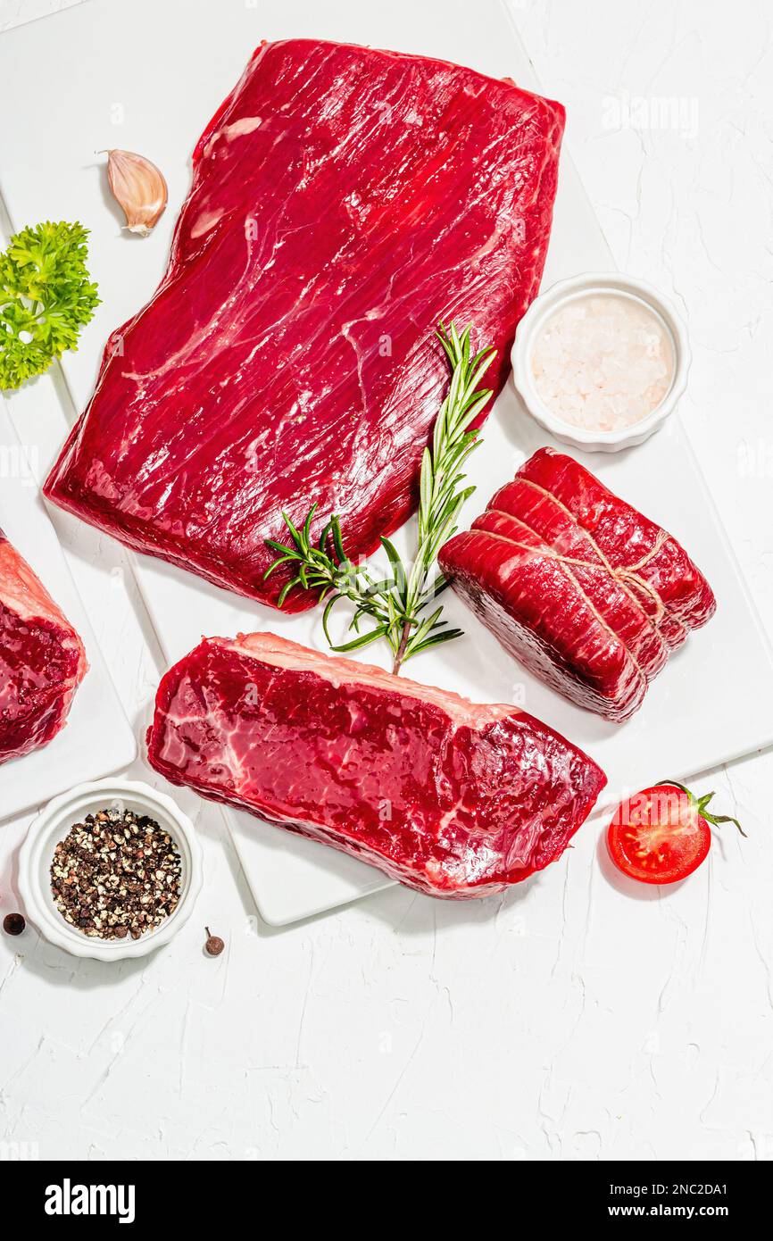 Set of various steaks with spices and herbs. Classic raw meat cuts ...