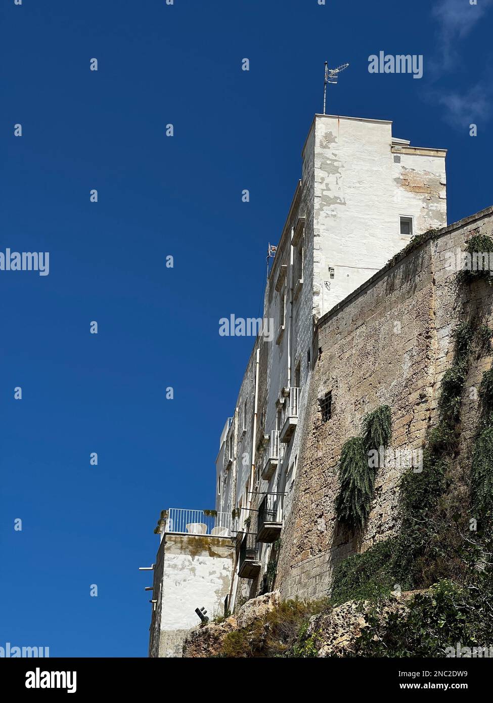 A stone house and terrace overlooks the Adriatic Sea in Polignano a ...