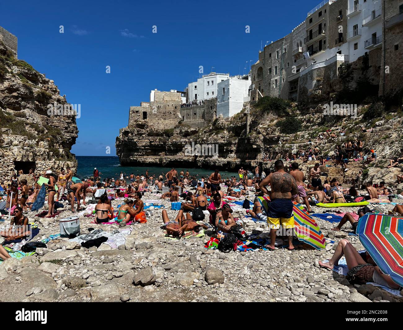Sunbathers enjoy the Lido Cala Paura Beach in Polignano a Mare, Italy ...