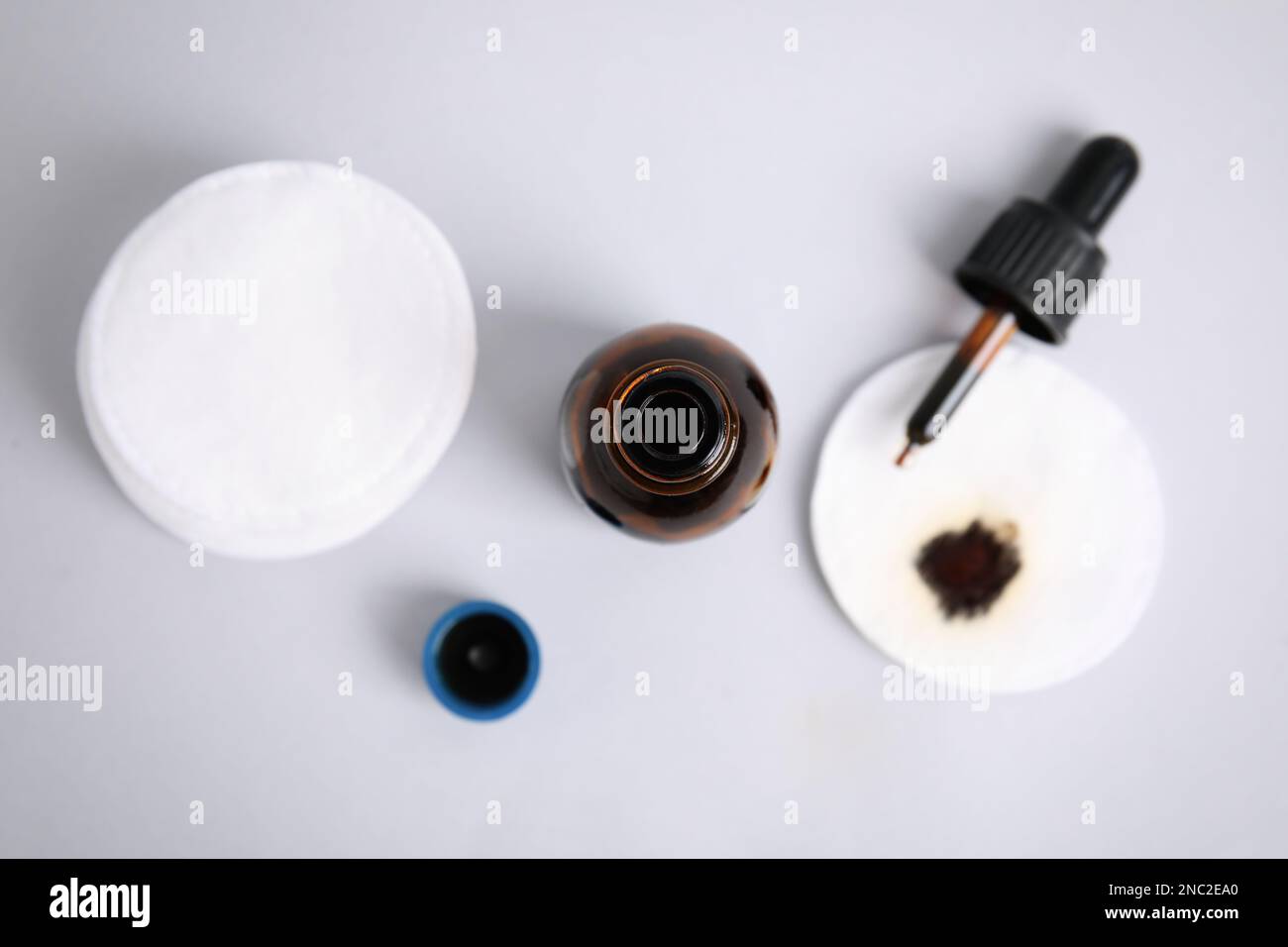 Bottle of medical iodine, dropper and cotton pads on grey background ...