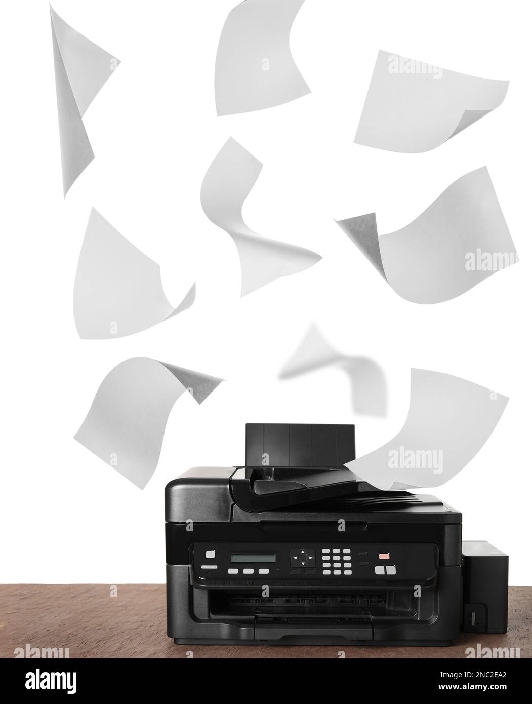 Modern multifunction printer on table and flying sheets of paper ...
