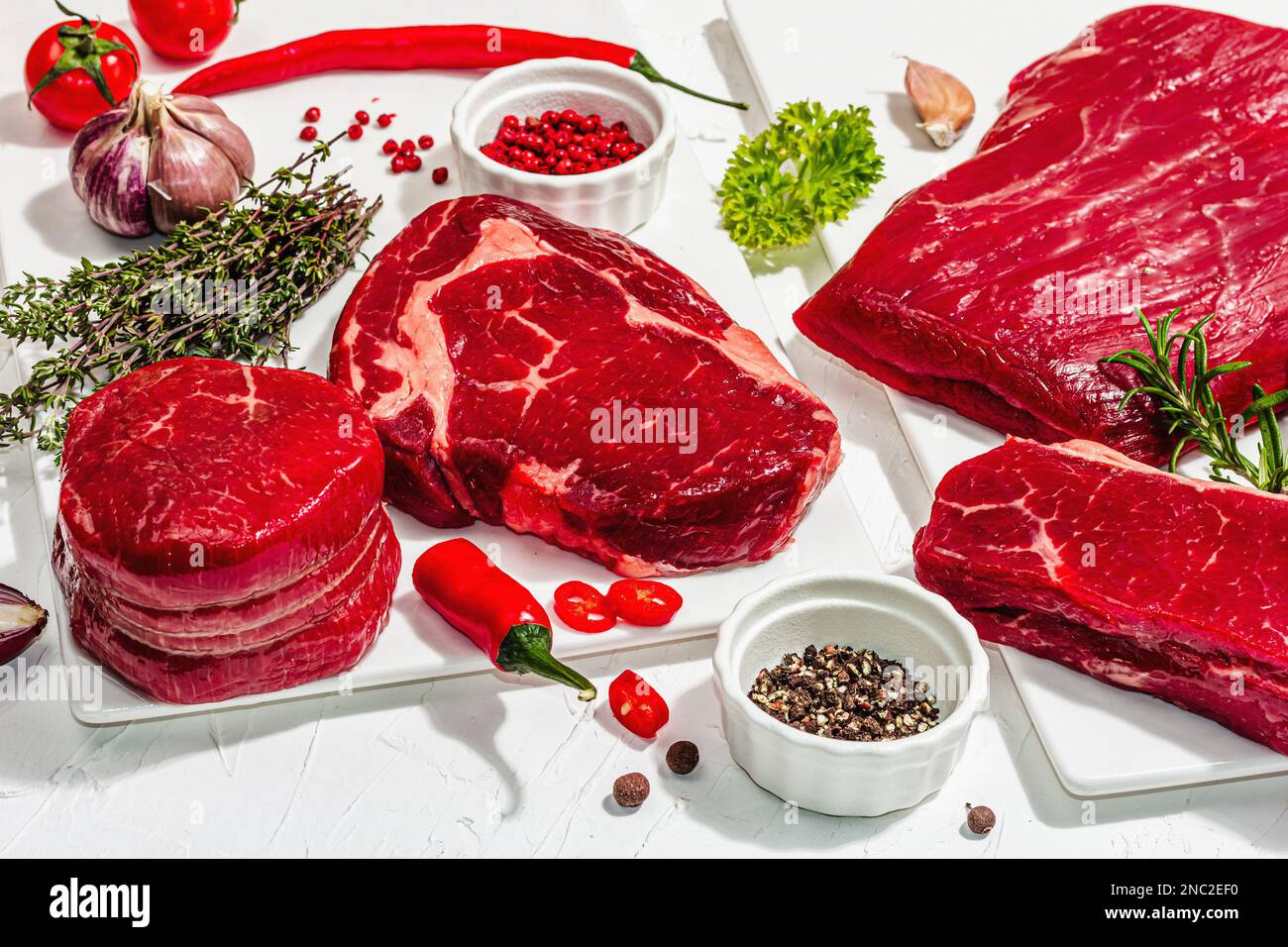 Set of various steaks with spices and herbs. Classic raw meat cuts ...