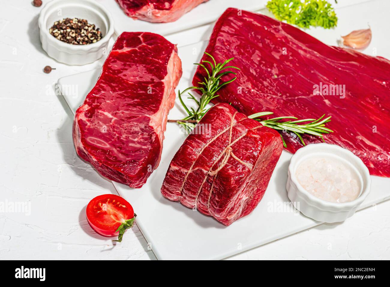 Set of various steaks with spices and herbs. Classic raw meat cuts ...