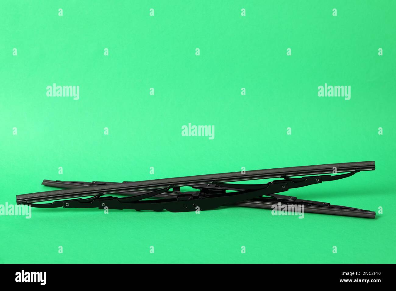 Car windshield wipers on green background. Space for text Stock Photo ...