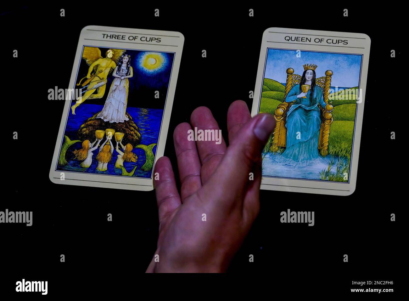 A young man is reading tarot cards to his client Stock Photo - Alamy