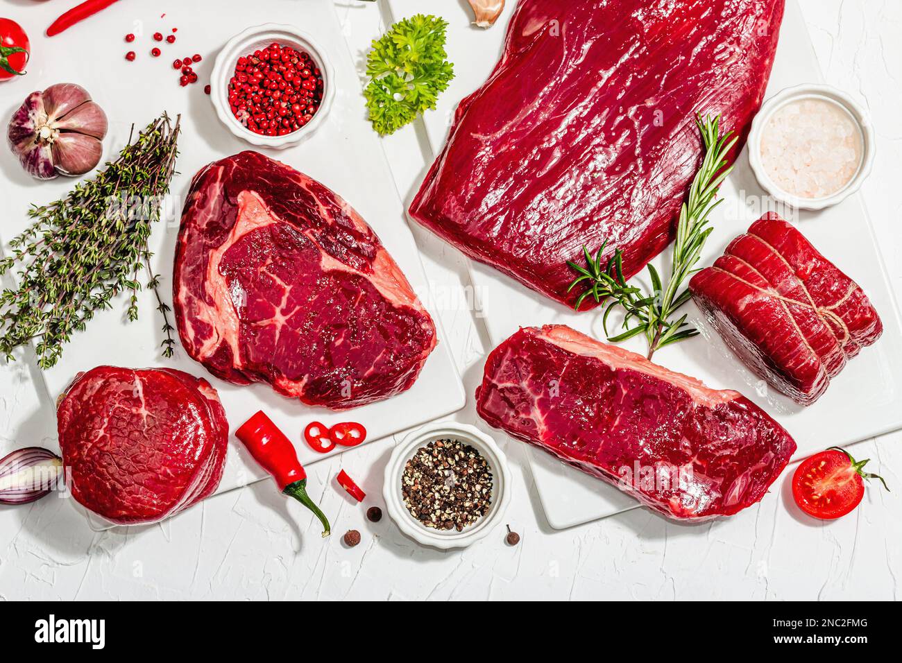 Set of various steaks with spices and herbs. Classic raw meat cuts ...
