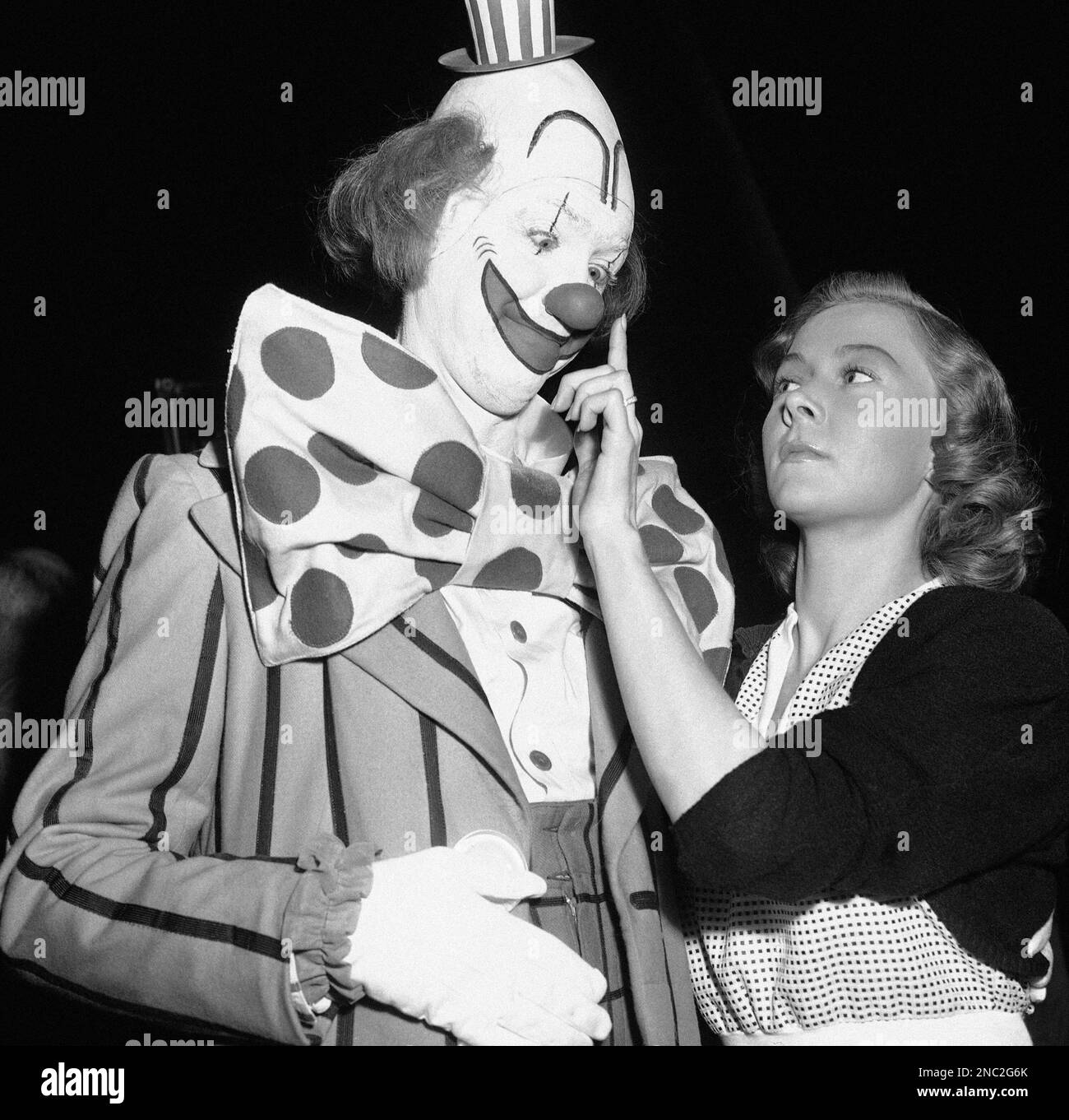 Actress Gloria Grahame tests the plastic nose worn by James Stewart in ...