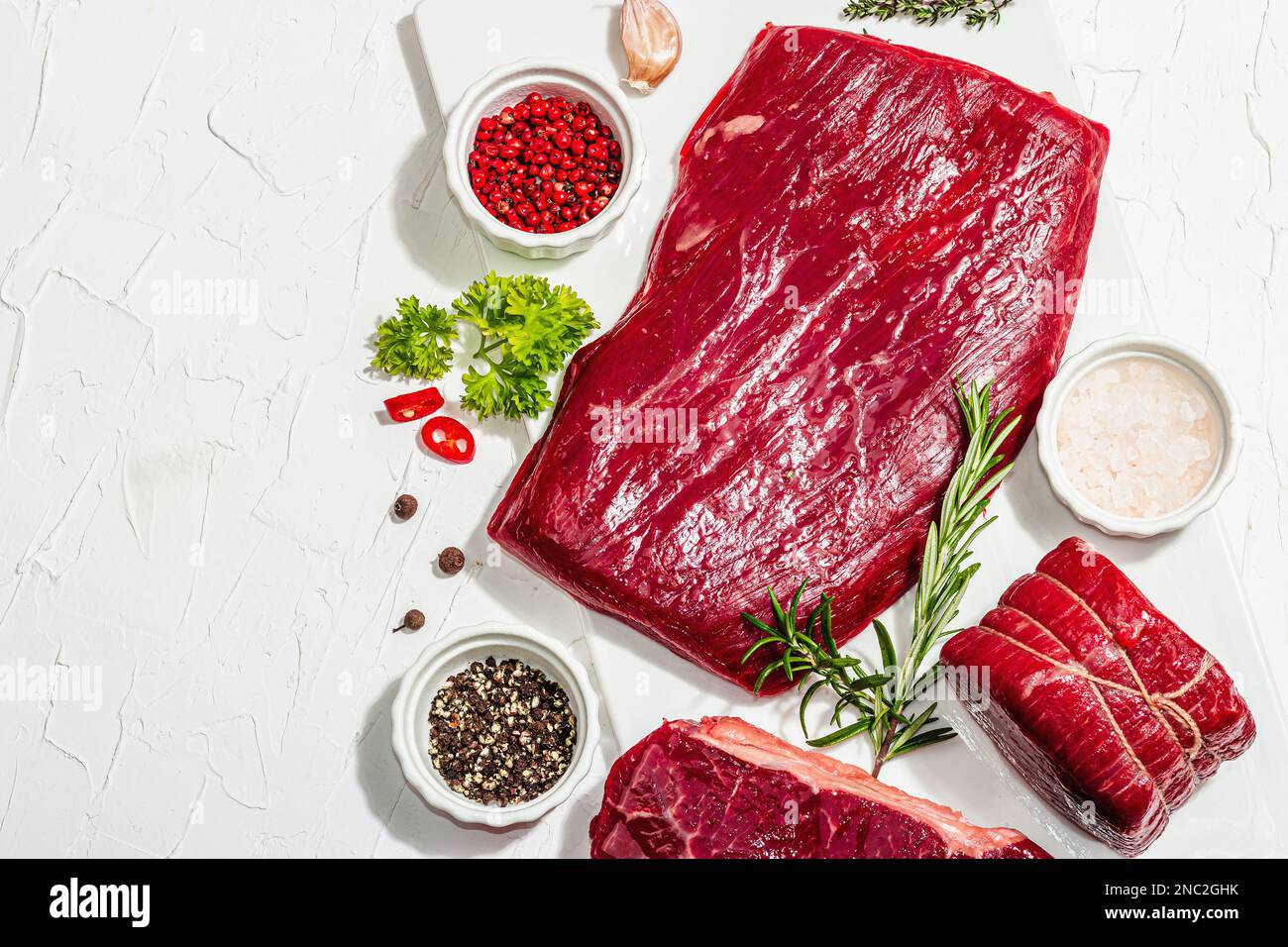 Set of various steaks with spices and herbs. Classic raw meat cuts ...