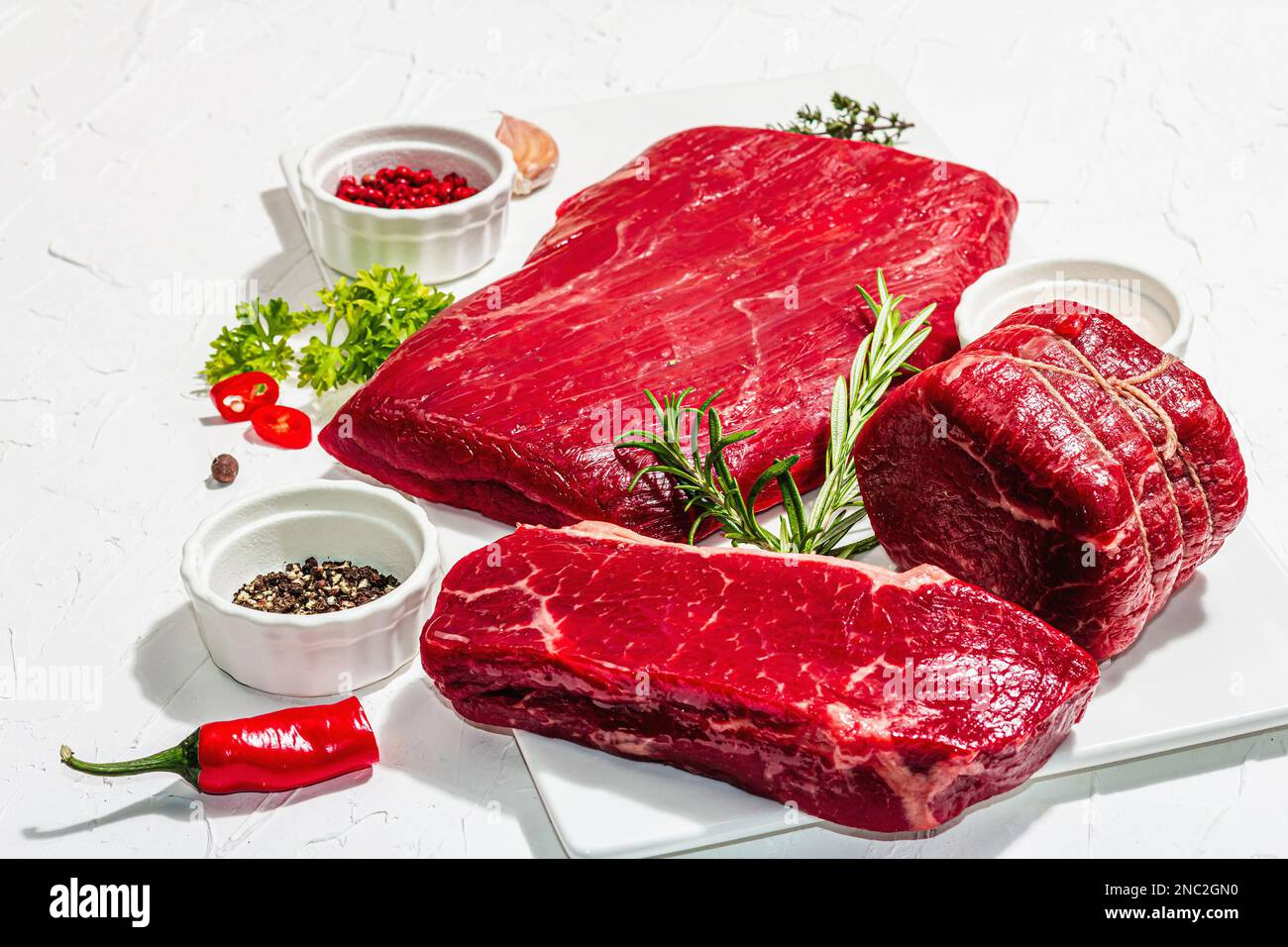 Set of various steaks with spices and herbs. Classic raw meat cuts ...