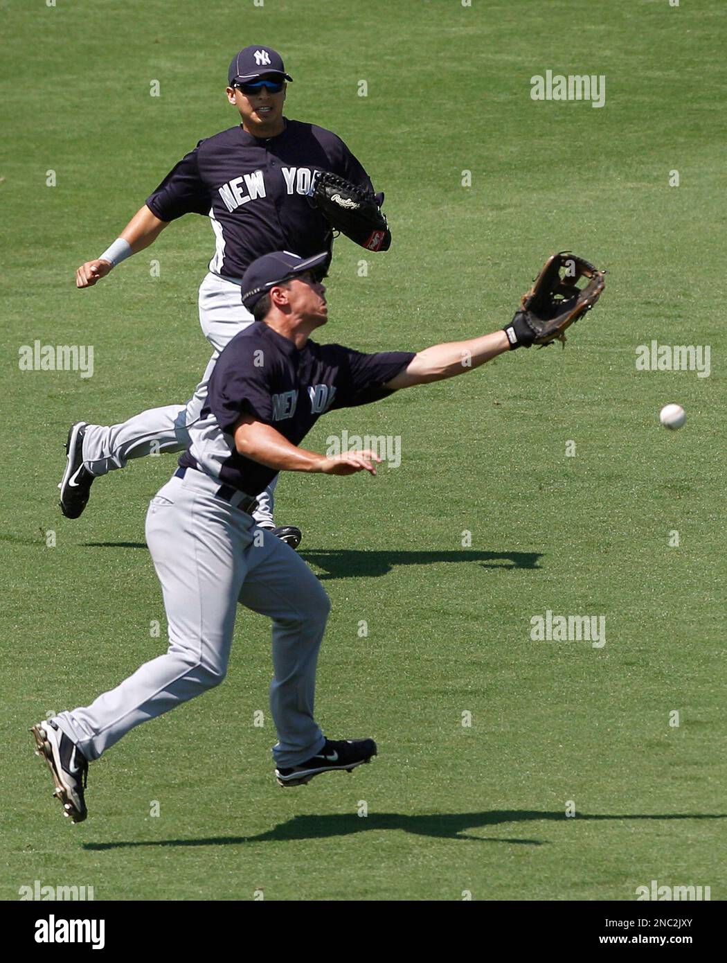 New York Yankees shortstop Doug Bernier, foreground, cannot make the ...