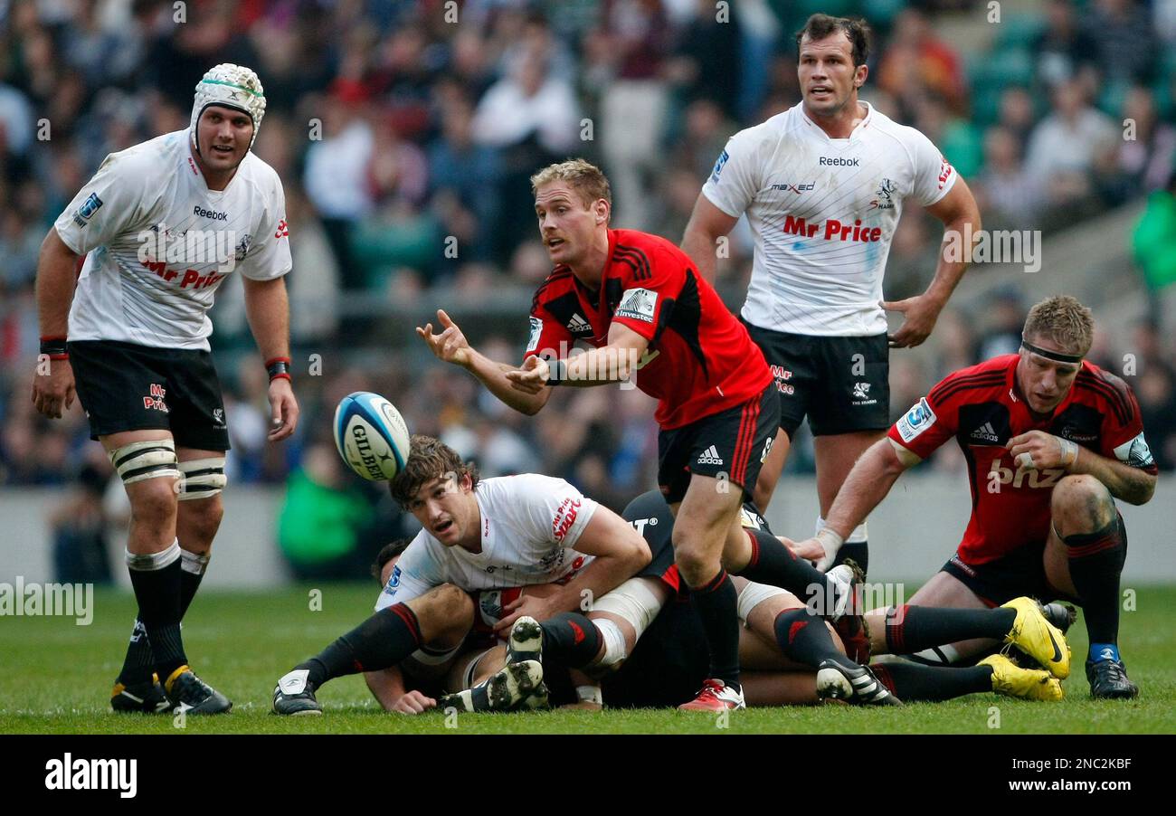 Crusaders' Andrew Ellis, center, passes the ball against the Sharks ...