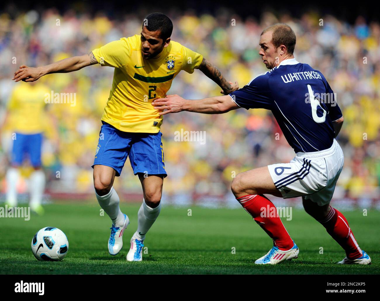 Brazil's Daniel Alves, left, takes the ball paat Scotland's Steven ...