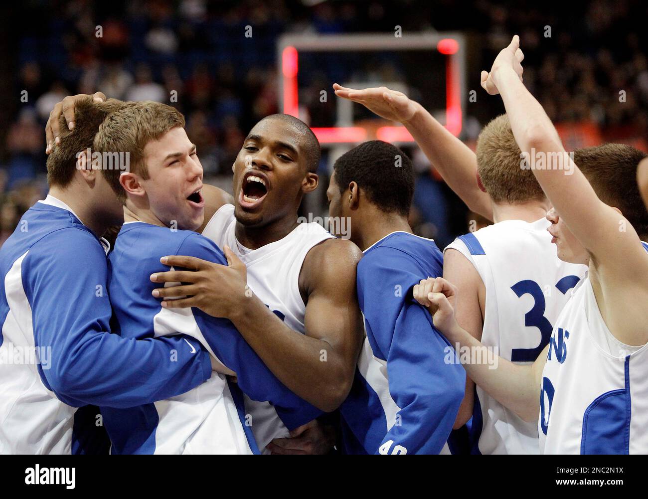 Members of the Hopkins basketball team celebrate their win against Eden ...