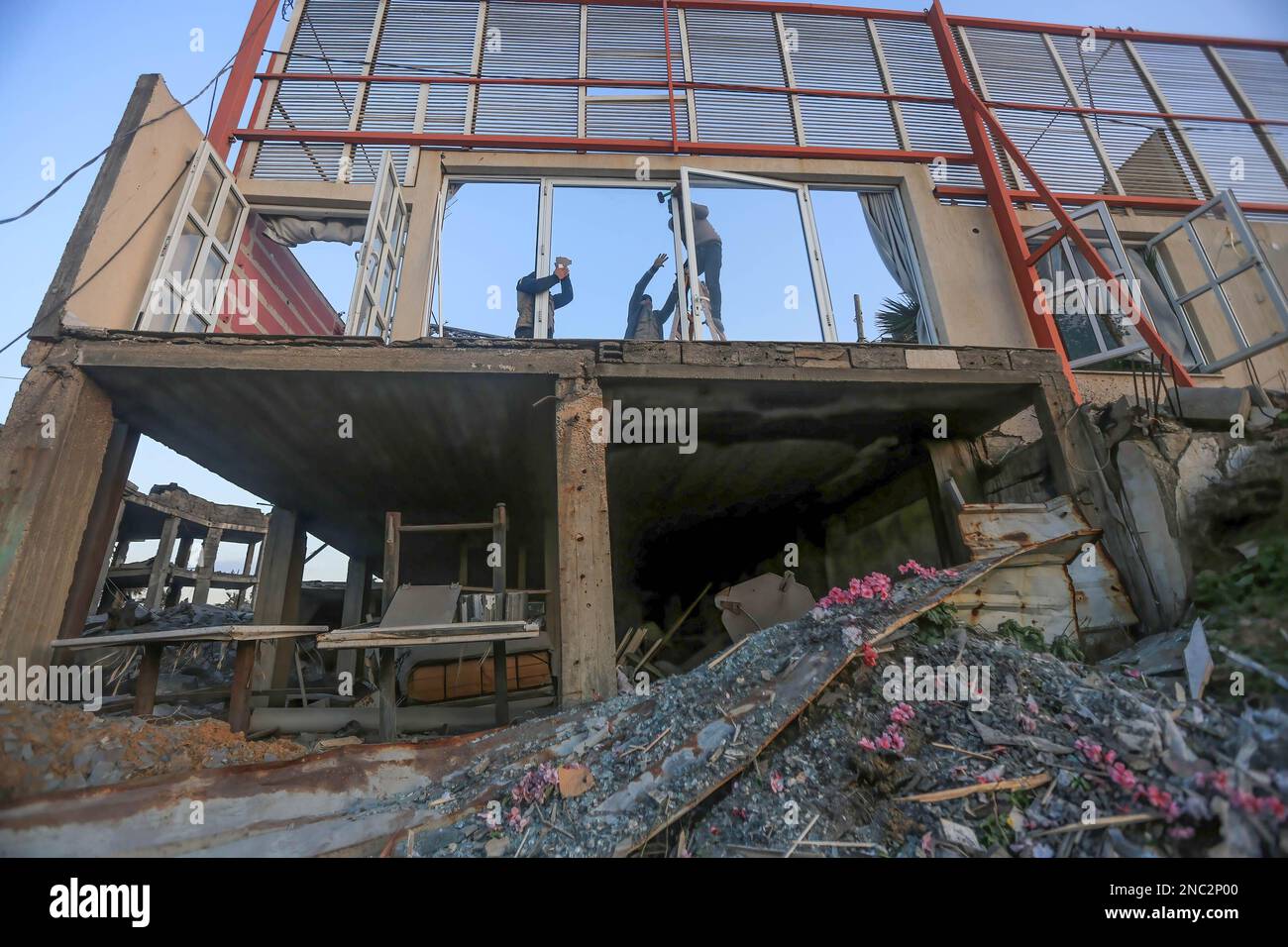 Palestinians inspect a destroyed wedding hall after being attacked by ...