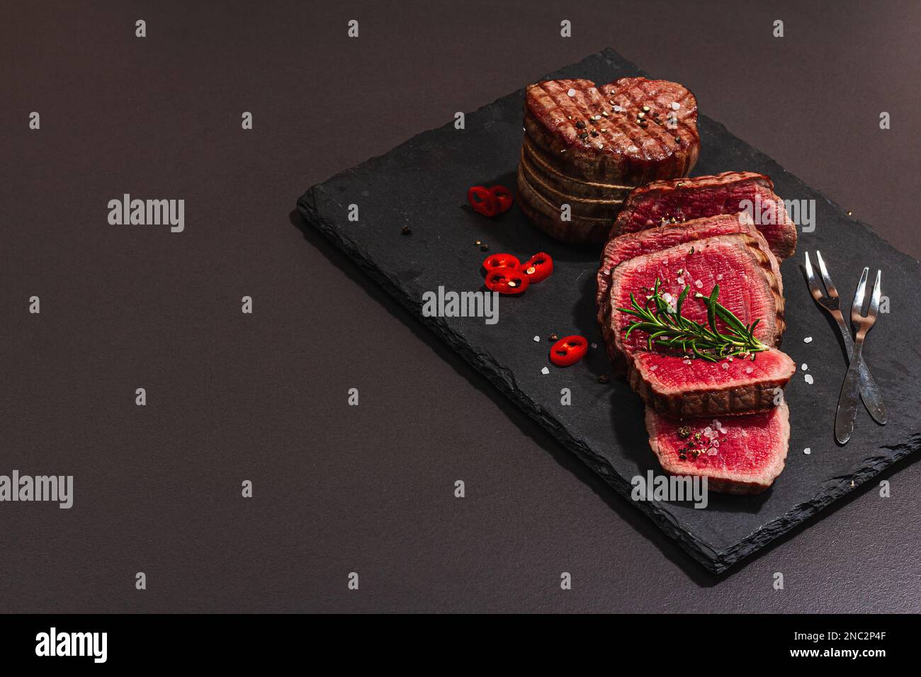 Rare cooking level Eye round steak with spices and herbs. Classic ...