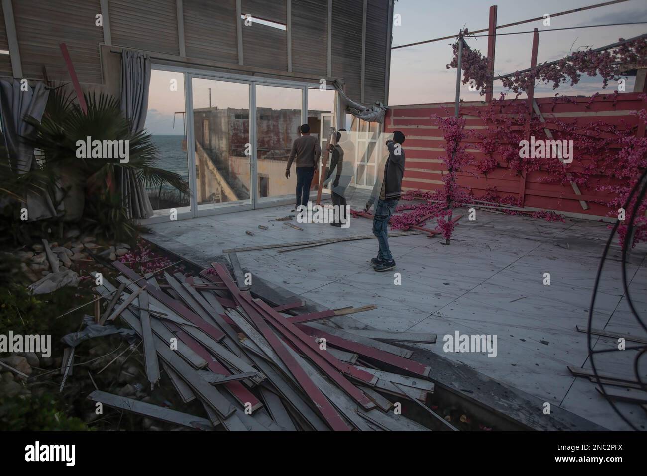 Palestinians walk with what's left of their belongings after the ...