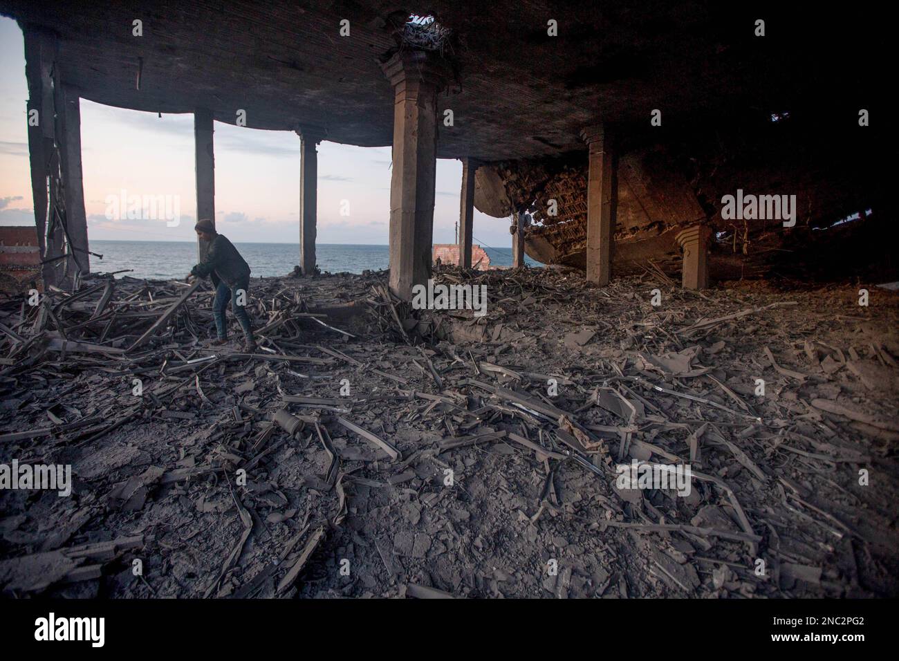 A Palestinian inspects a destroyed wedding hall after being attacked by ...