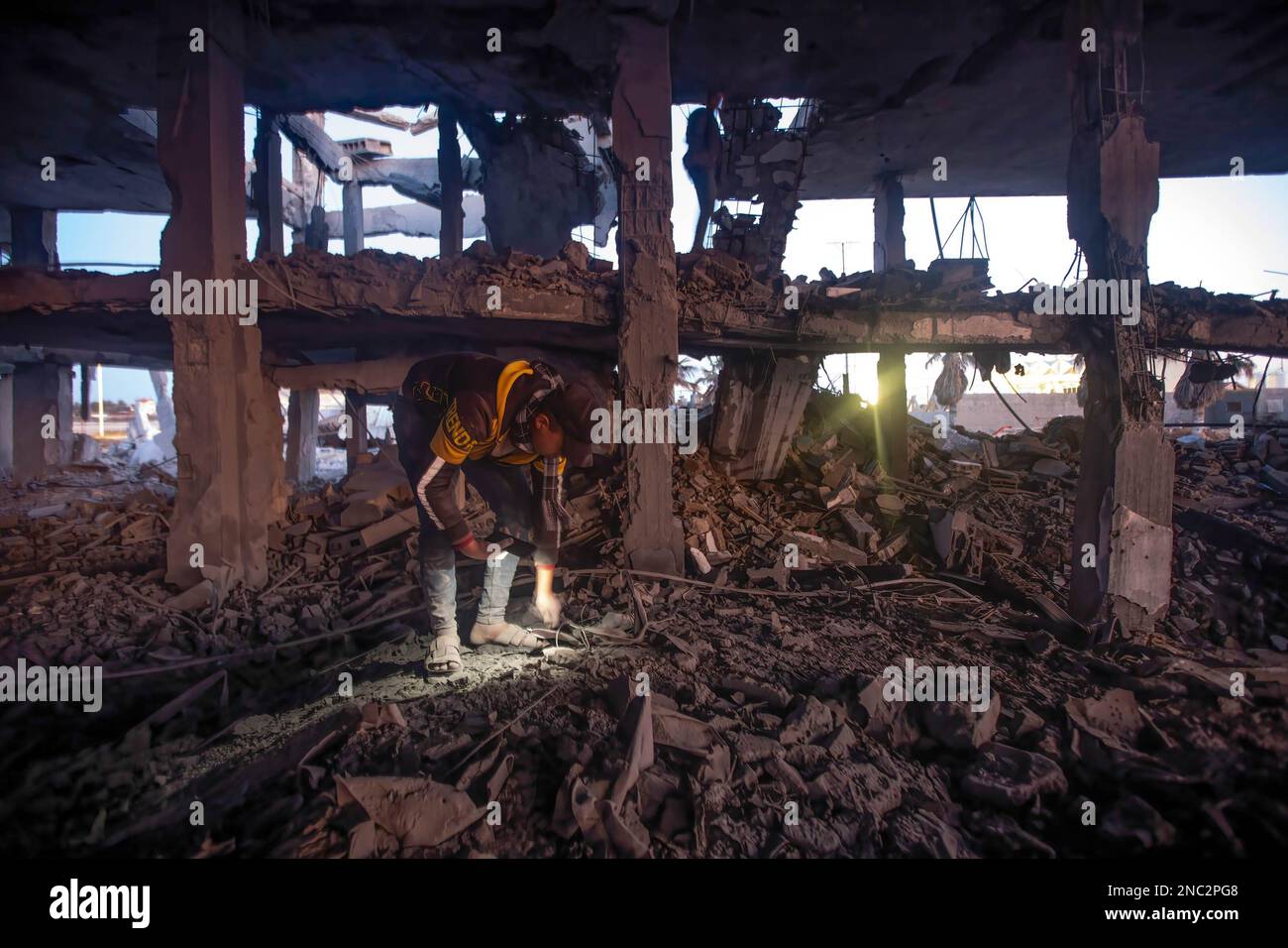 A Palestinian inspects a destroyed wedding hall after being attacked by ...