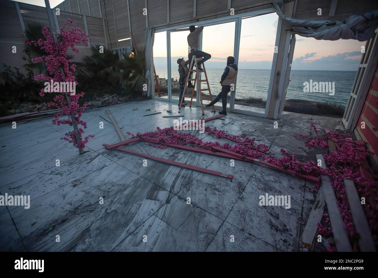 Palestinians inspect a destroyed wedding hall after being attacked by ...