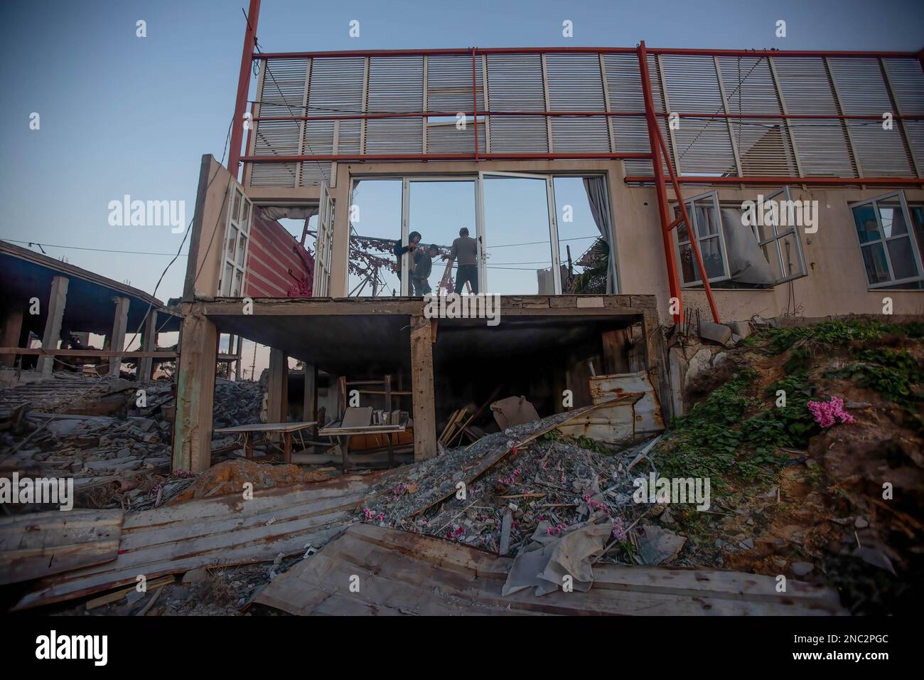 Palestinians inspect a destroyed wedding hall after being attacked by ...