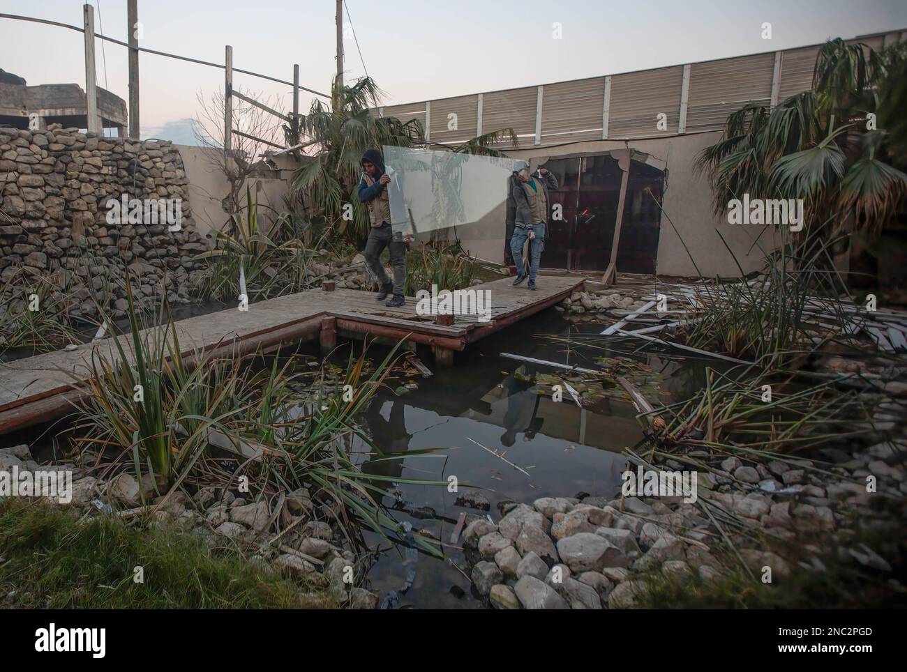 Palestinians walk with what's left of their belongings after the ...