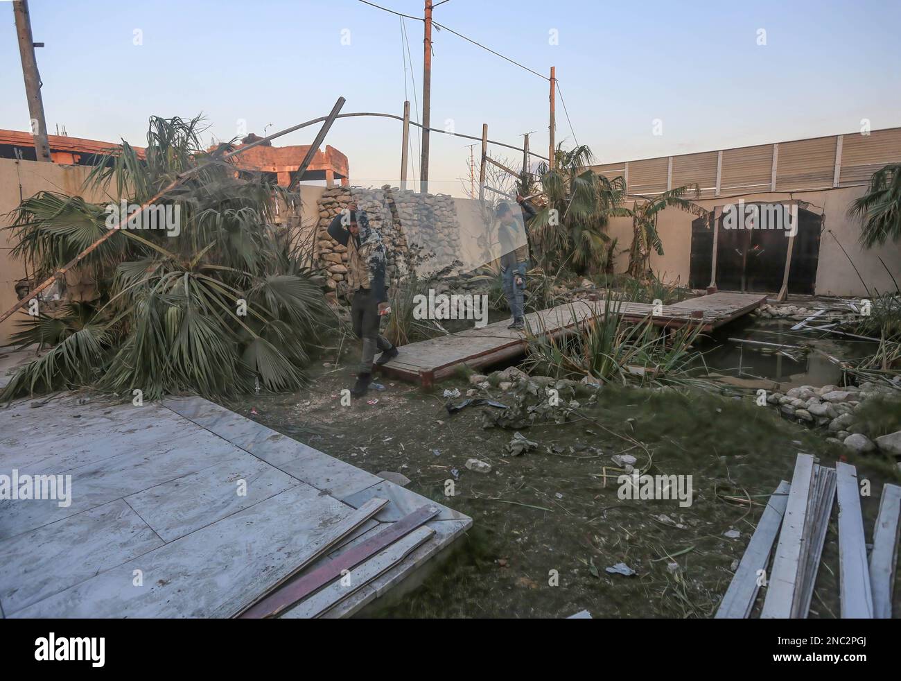 Palestinians walk with what's left of their belongings after the ...