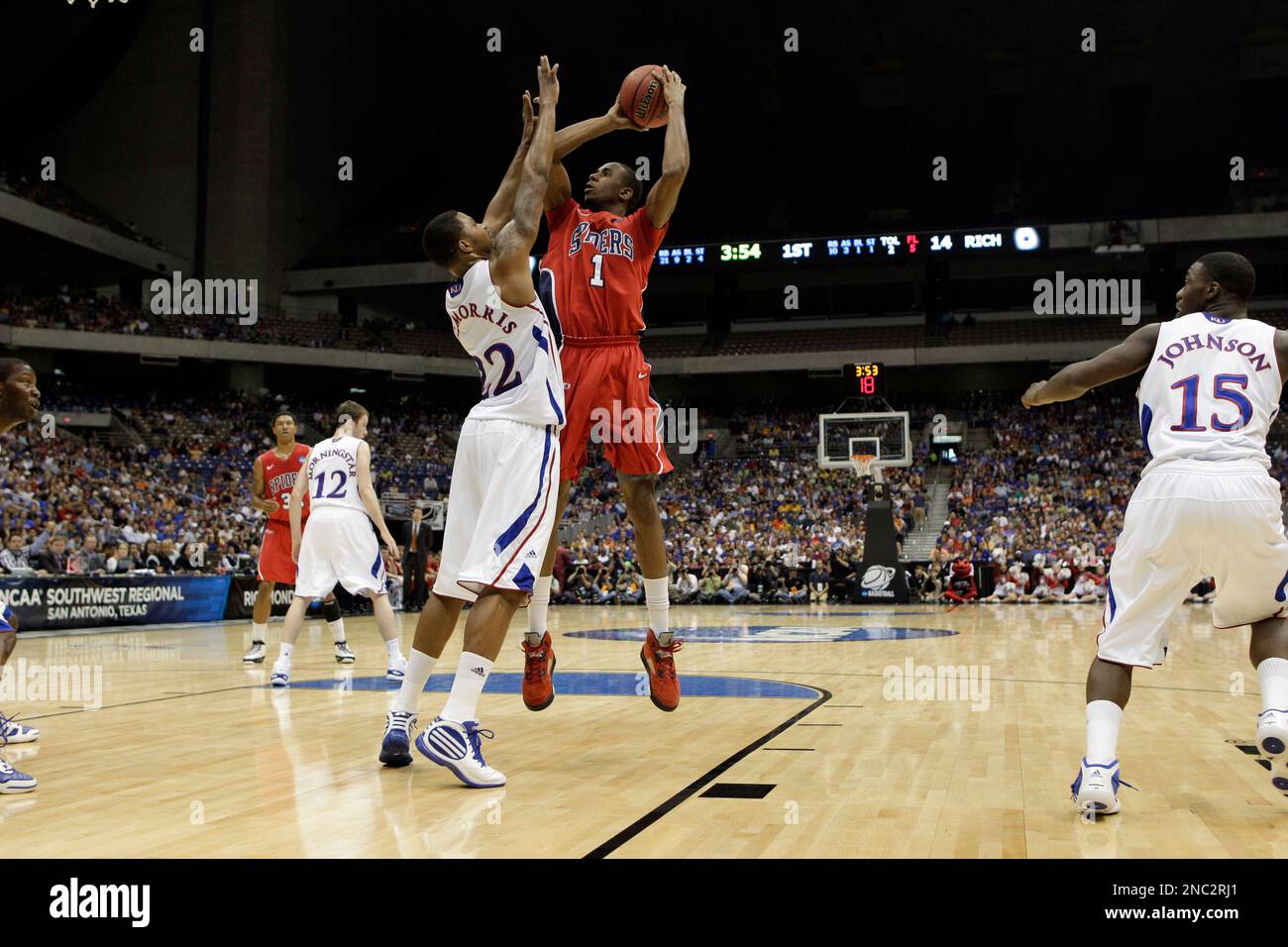 Richmond's Darrius Garrett shoots over Kansas' Marcus Morris during the first half of a ...