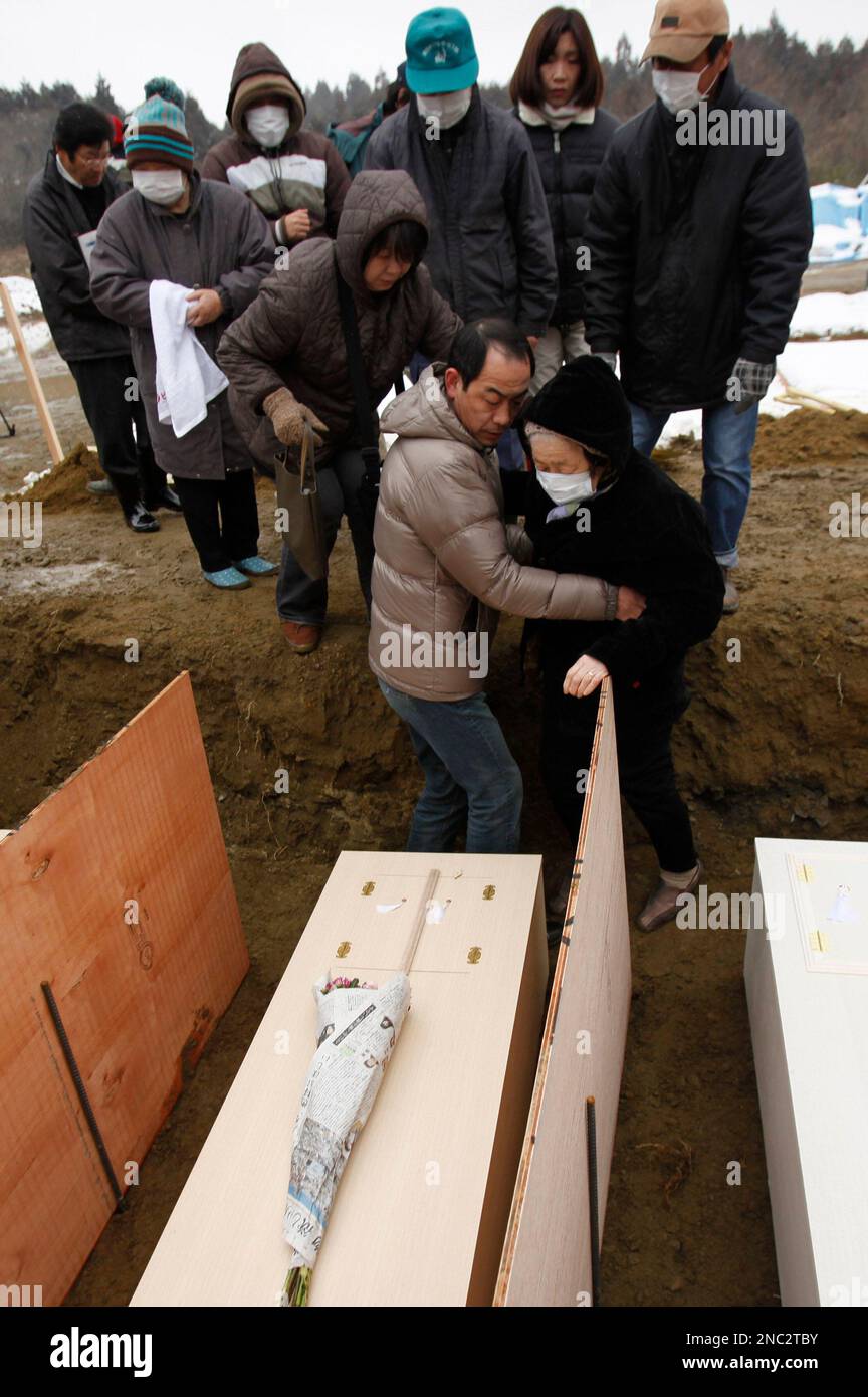 Japanese approach to the coffin of their loved one during a mass ...
