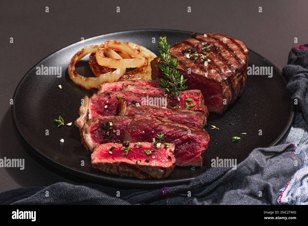 Rare cooking level Sirloin steak with spices and herbs. Classic grilled ...