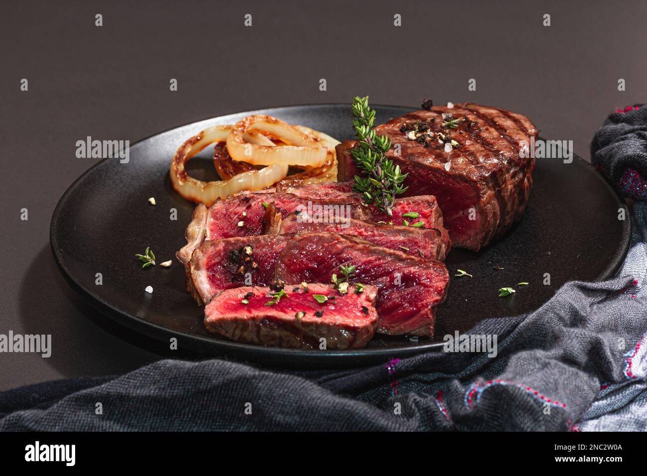 Rare cooking level Sirloin steak with spices and herbs. Classic grilled ...