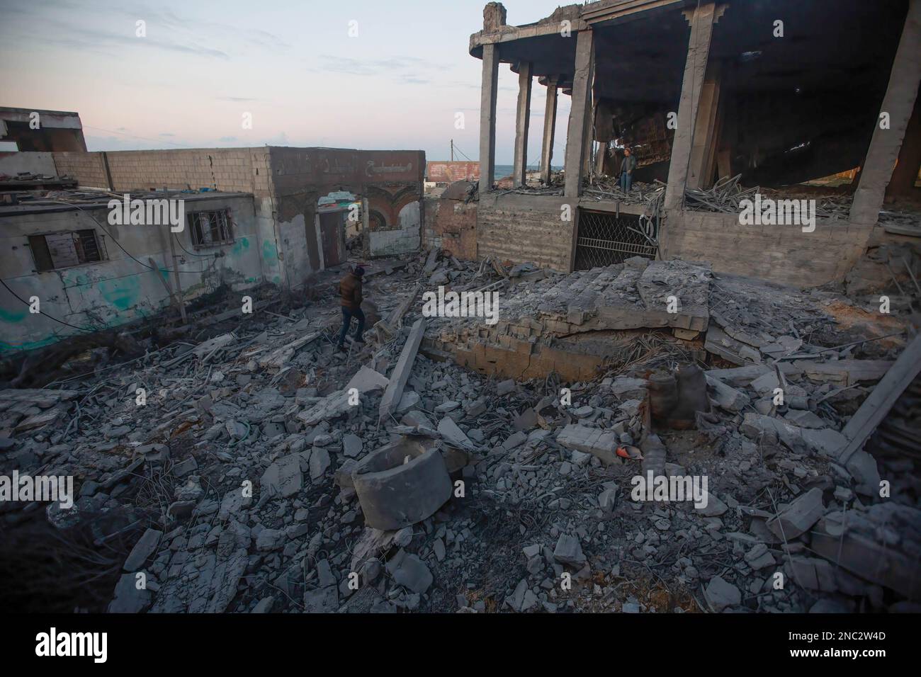 Palestinians inspect a destroyed wedding hall after being attacked by ...