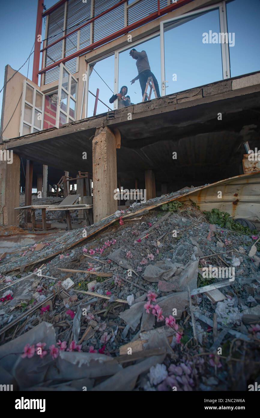 Palestinians inspect a destroyed wedding hall after being attacked by ...