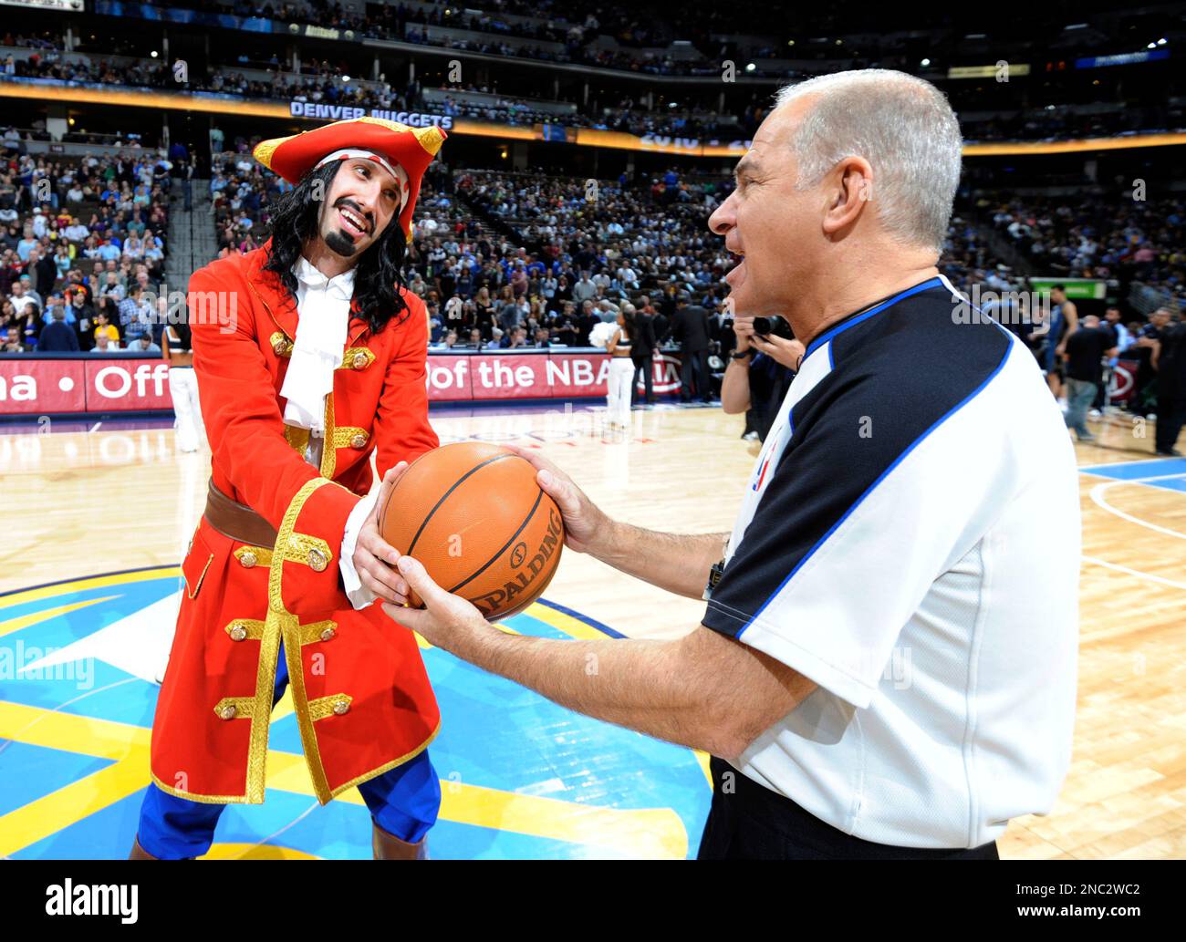 Captain Morgan delivers the game ball at an NBA basketball game between ...