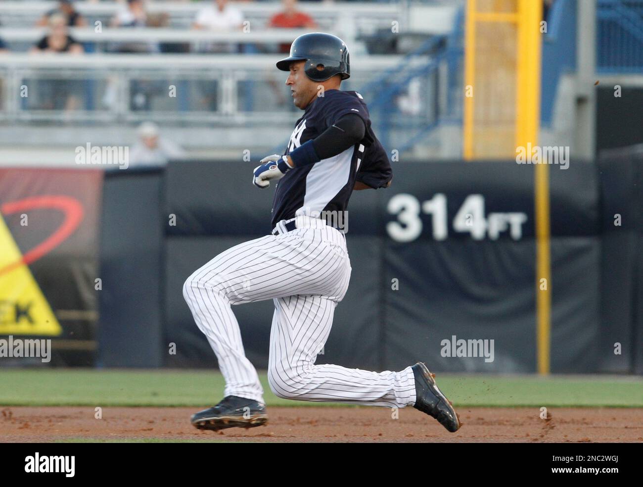 New York Yankees shortstop Derek Jeter slides into second in their ...