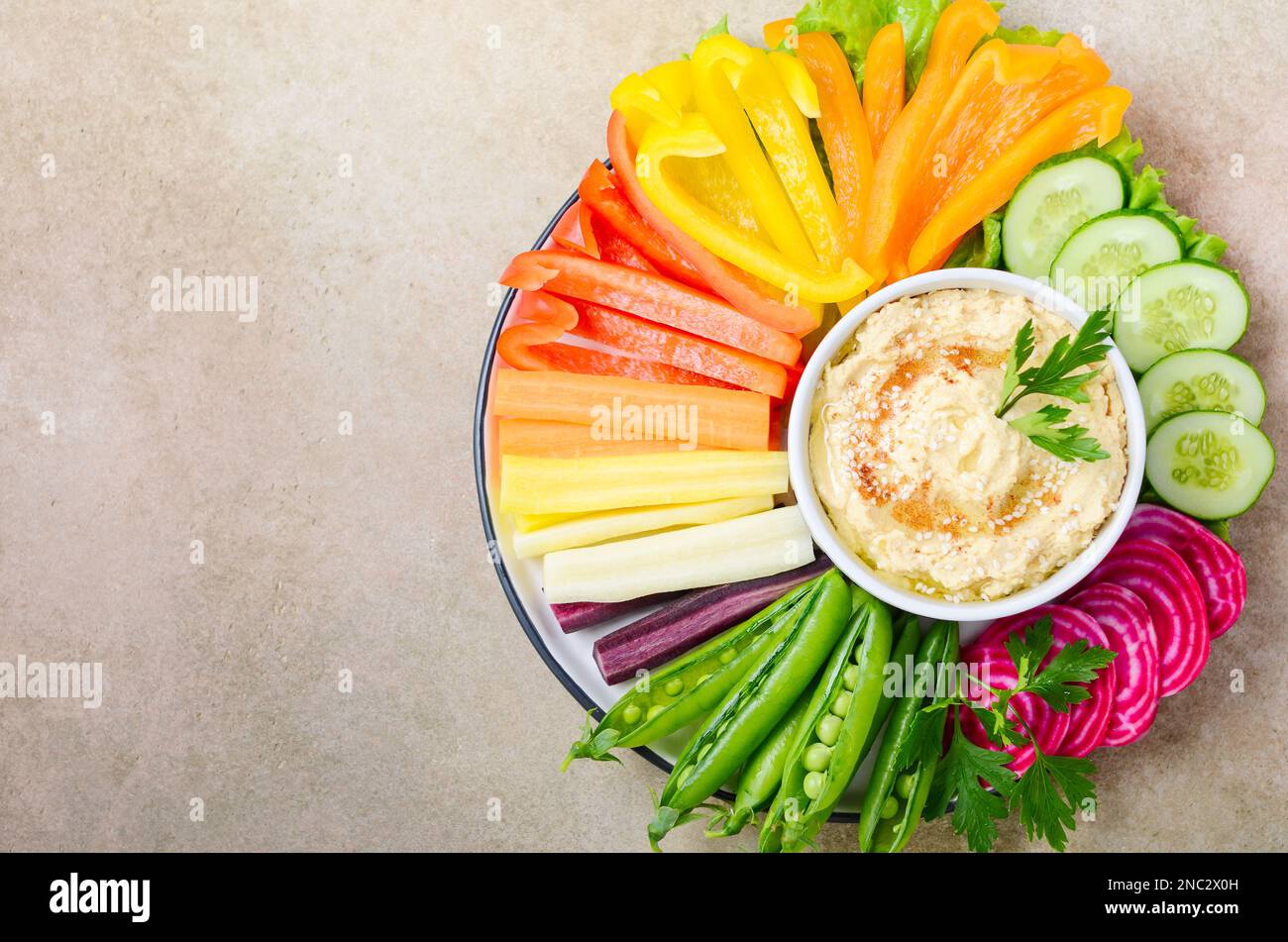 Hummus platter with assorted vegetable snacks. Healthy vegan and vegetarian food. Top view, flat ...