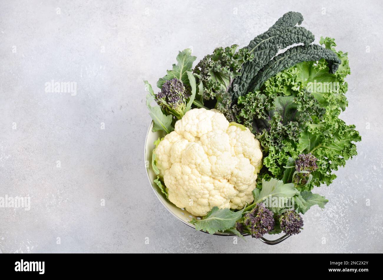 Different kinds of fresh organic cabbage on a gray concrete background ...