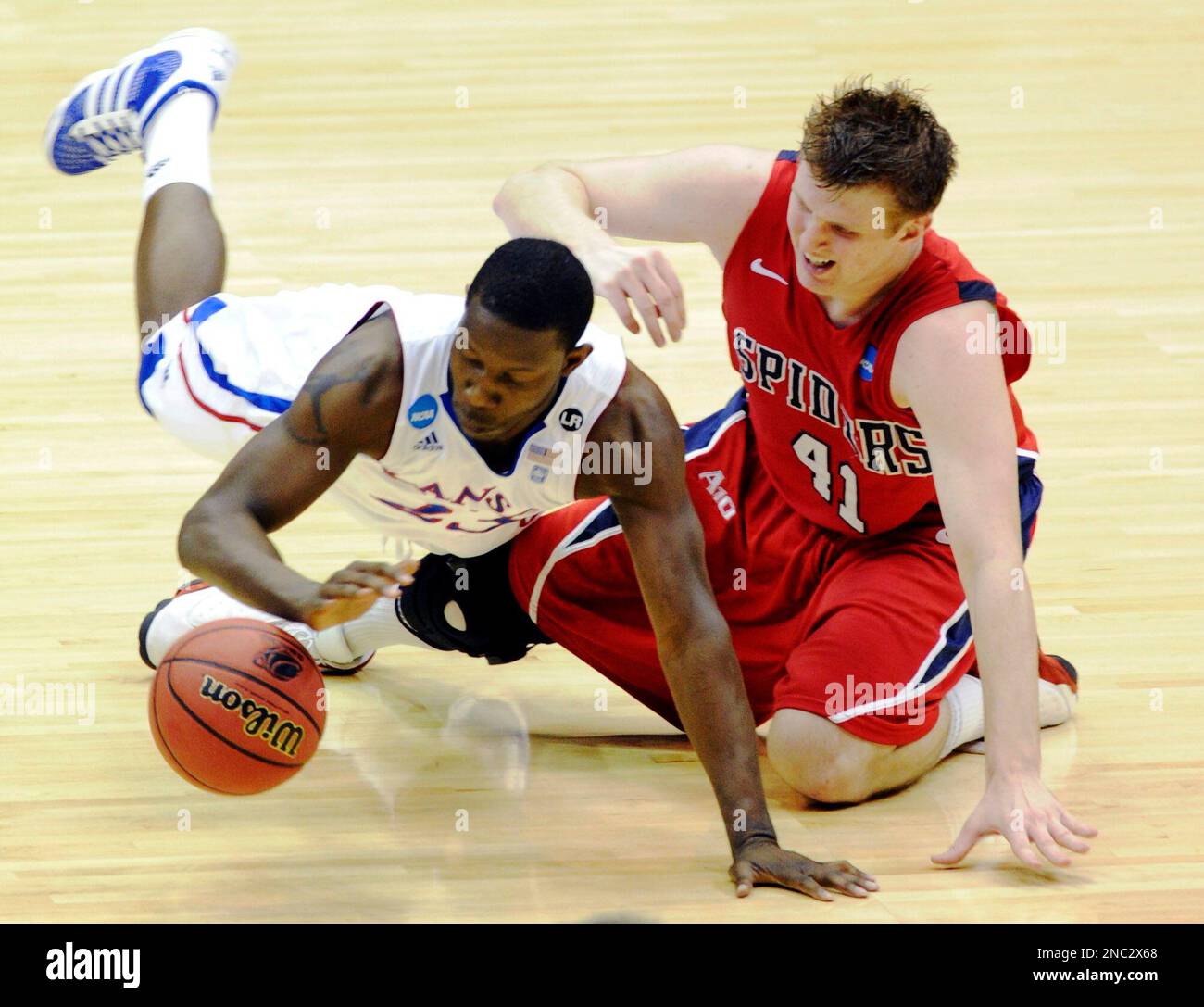 Kansas' Mario Little and Richmond's Dan Geriot go after a loose ball ...