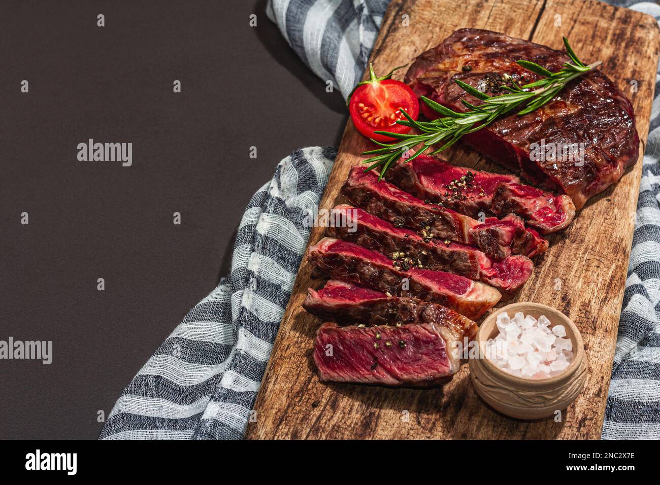 Rare cooking level Ribeye steak with spices and herbs. Classic grilled ...