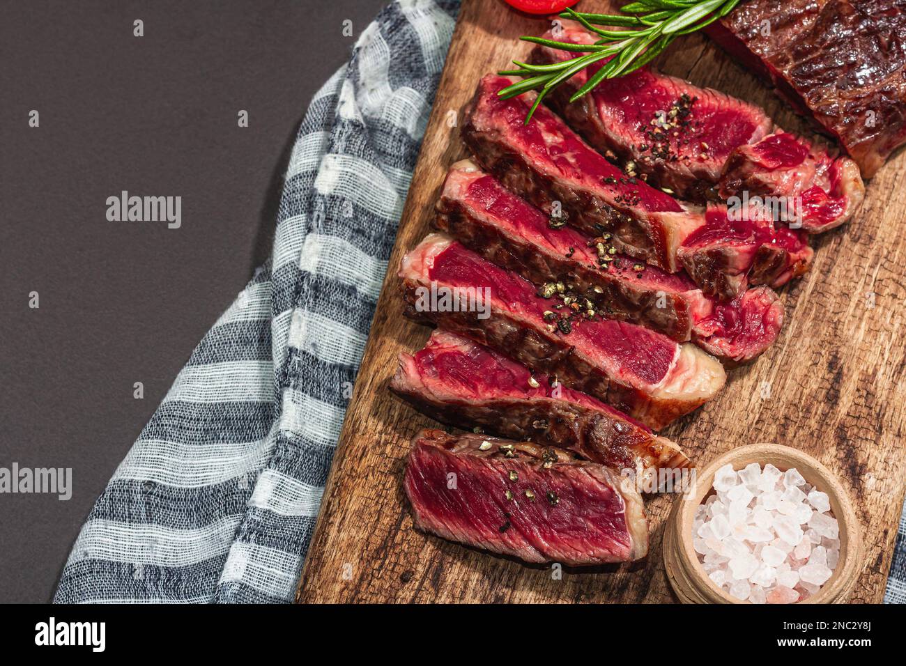 Rare cooking level Ribeye steak with spices and herbs. Classic grilled ...